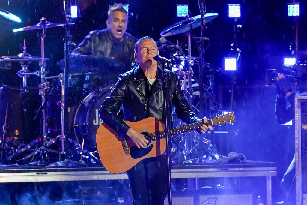 Uninvited Fan Interrupts Bryan Adams Mid-Performance For a Duet of ...